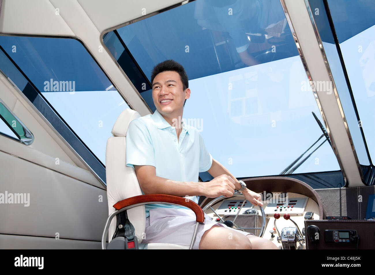 Man in a Yacht Cockpit Stock Photo - Alamy