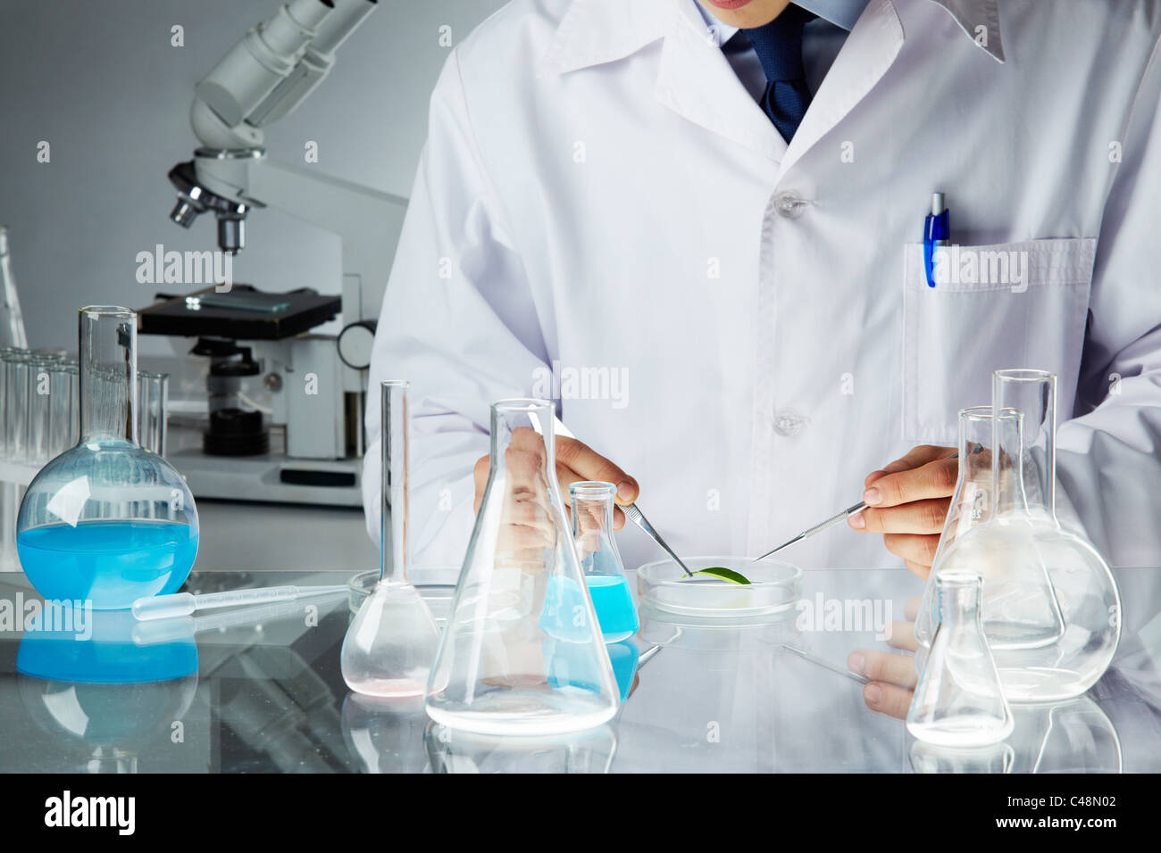 Hands of clinician holding steel tools during scientific experiment in ...