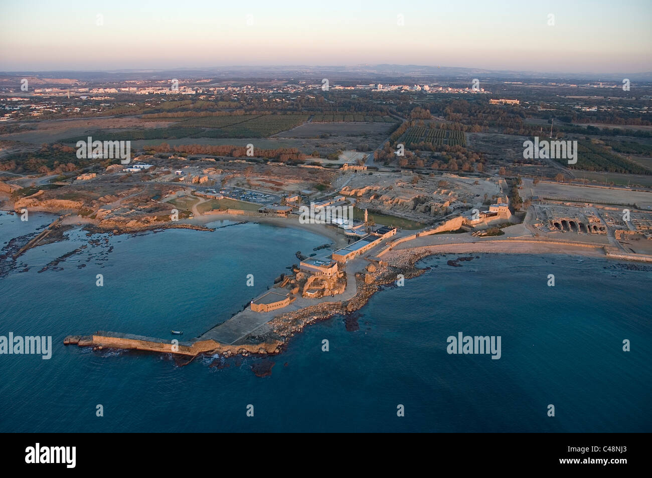 Aerial photograph of the ancient port of Caesarea at sunset Stock Photo ...