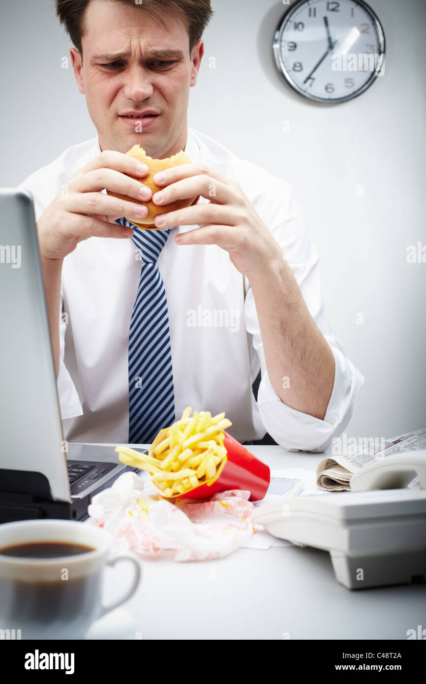 Portrait disgusted businessman eating hamburger hi-res stock ...