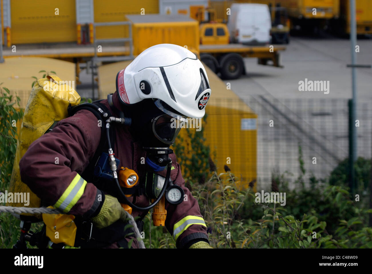 London Firefighter at a blaze in an Essex scrapyard Stock Photo - Alamy