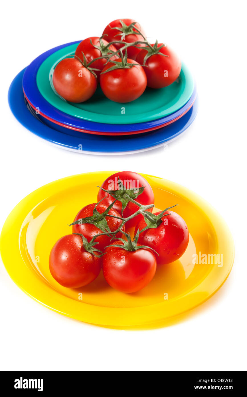 A plates of red tomatoes isolated on white Stock Photo - Alamy