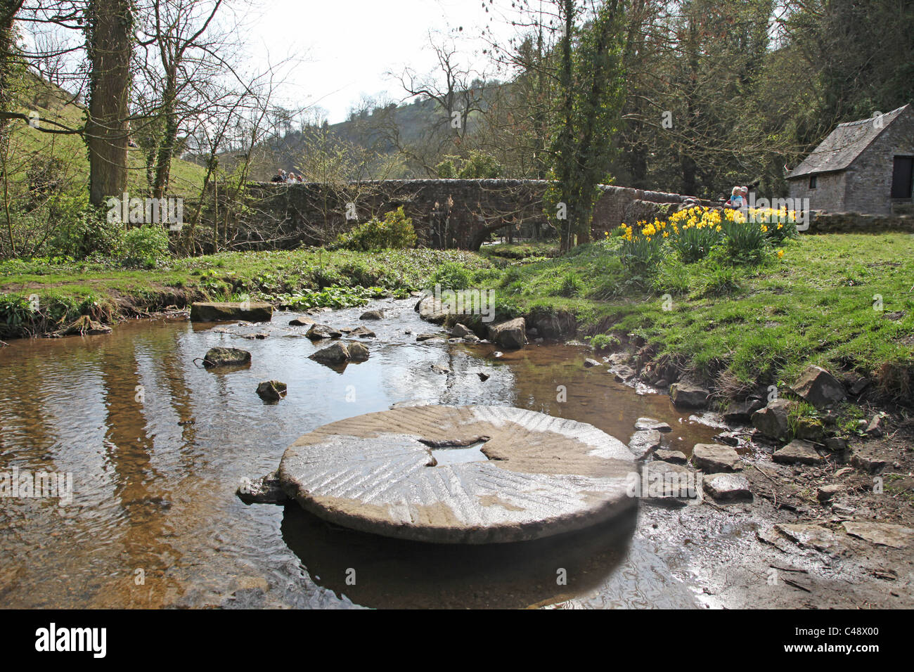 A mill stone in the River Dove with Viators Bridge Milldale on the ...