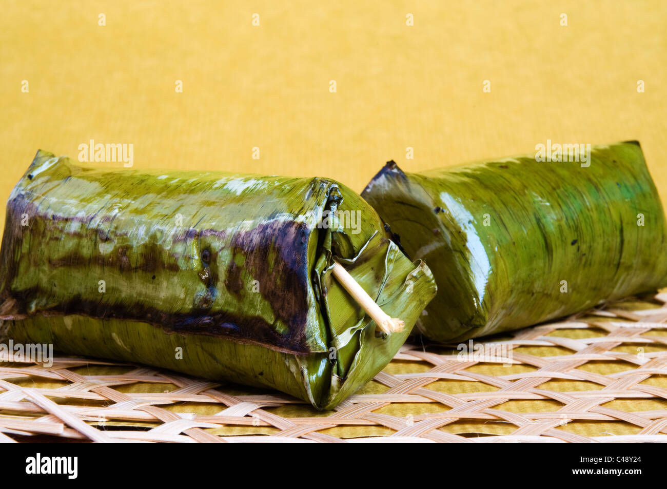 Indonesian leaf-wrapped sticky rice snacks - lempar Stock Photo - Alamy