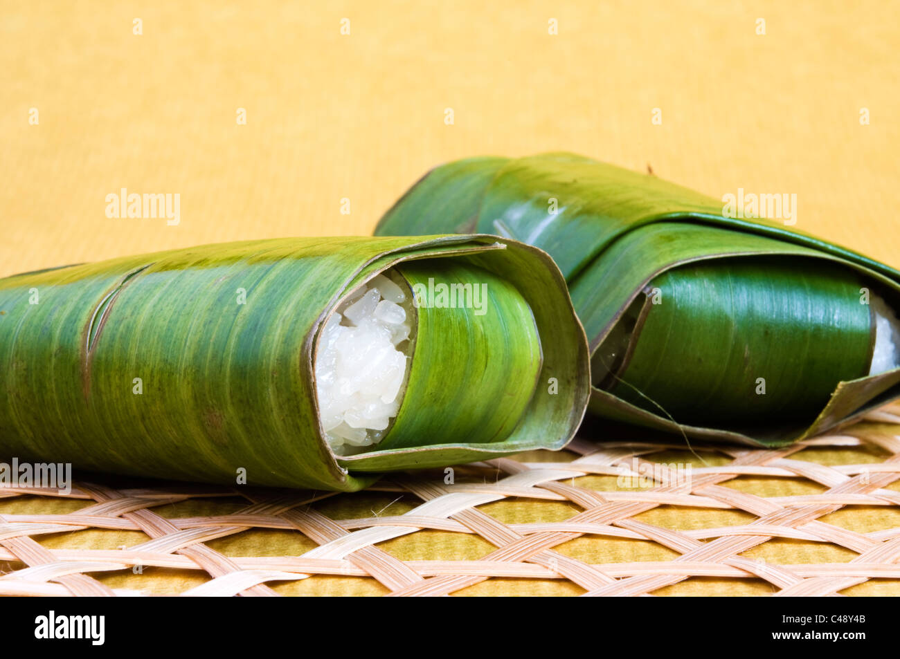 Indonesian leaf-wrapped sticky rice snacks - lempar Stock Photo - Alamy