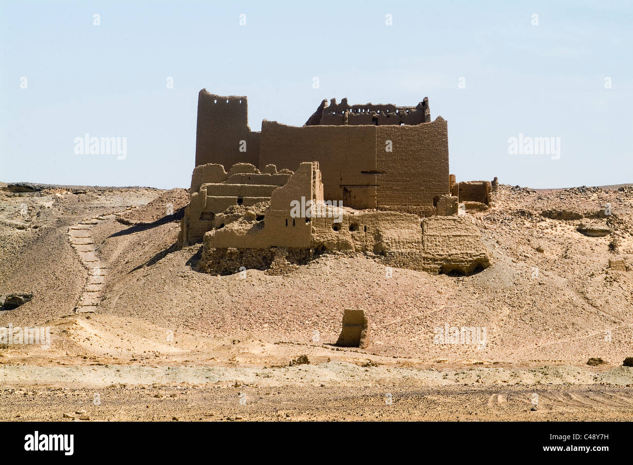 Photograph of the ruins of a castle in the sands of the western desert ...