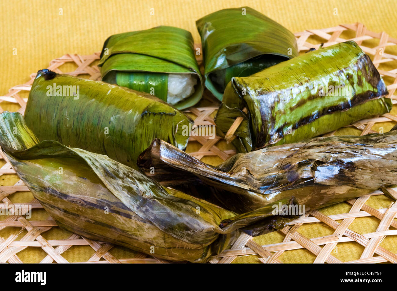 Indonesian leaf-wrapped sticky rice snacks - lempar Stock Photo - Alamy