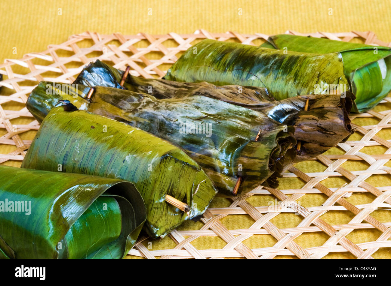 Indonesian leaf-wrapped sticky rice snacks - lempar Stock Photo - Alamy