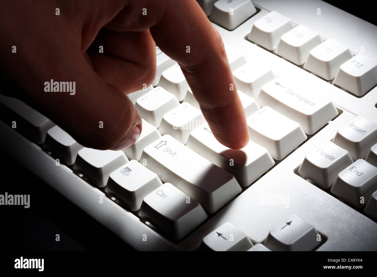 Close-up of male hand touching enter button on keyboard Stock Photo - Alamy