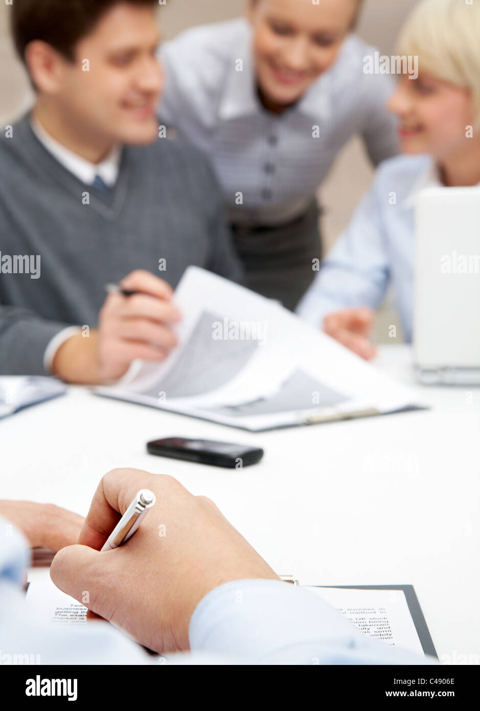 Photo of human hands making notes on background of man explaining idea ...