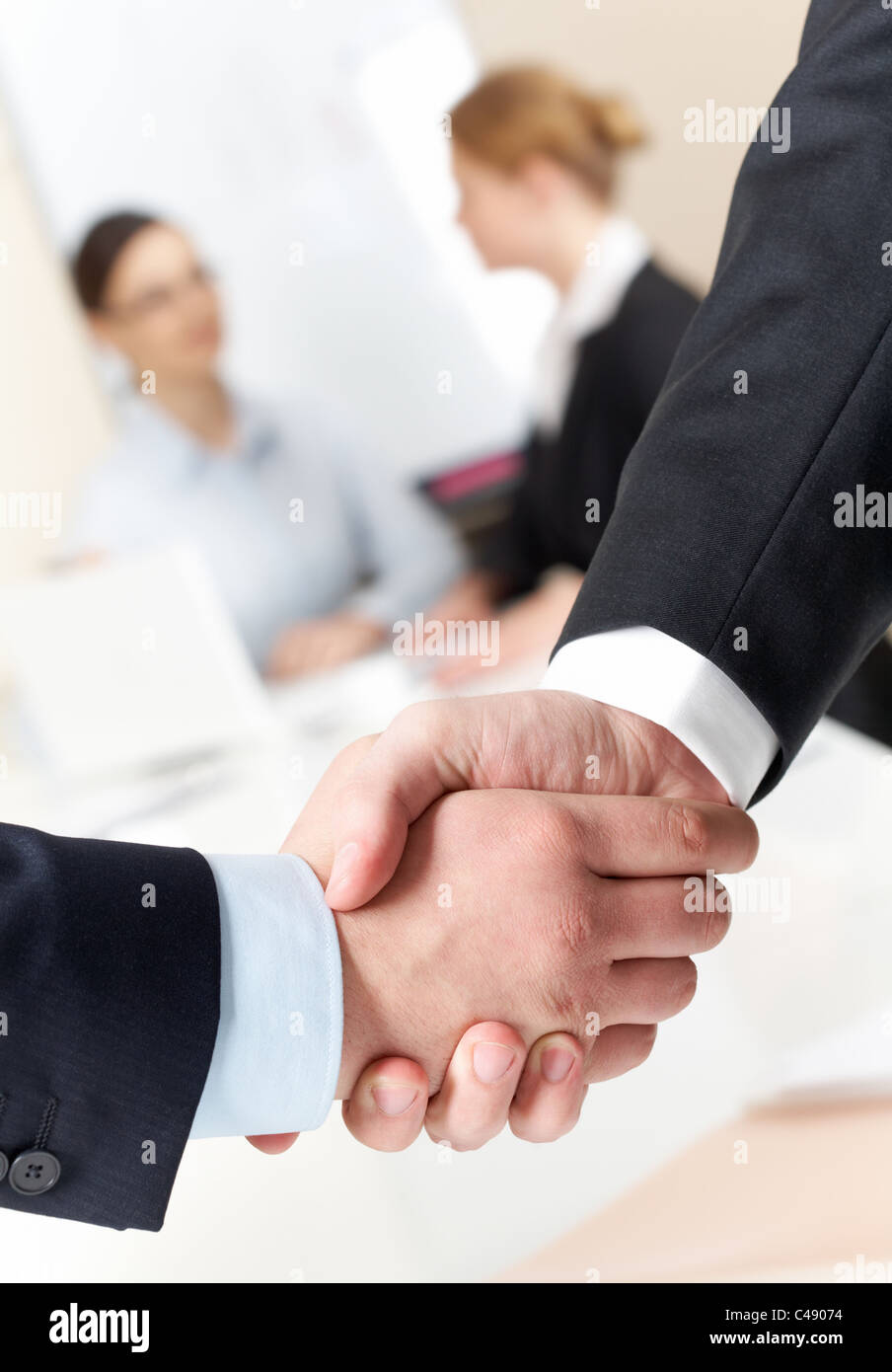 Photo of handshake of businessmen on background of communicating co ...
