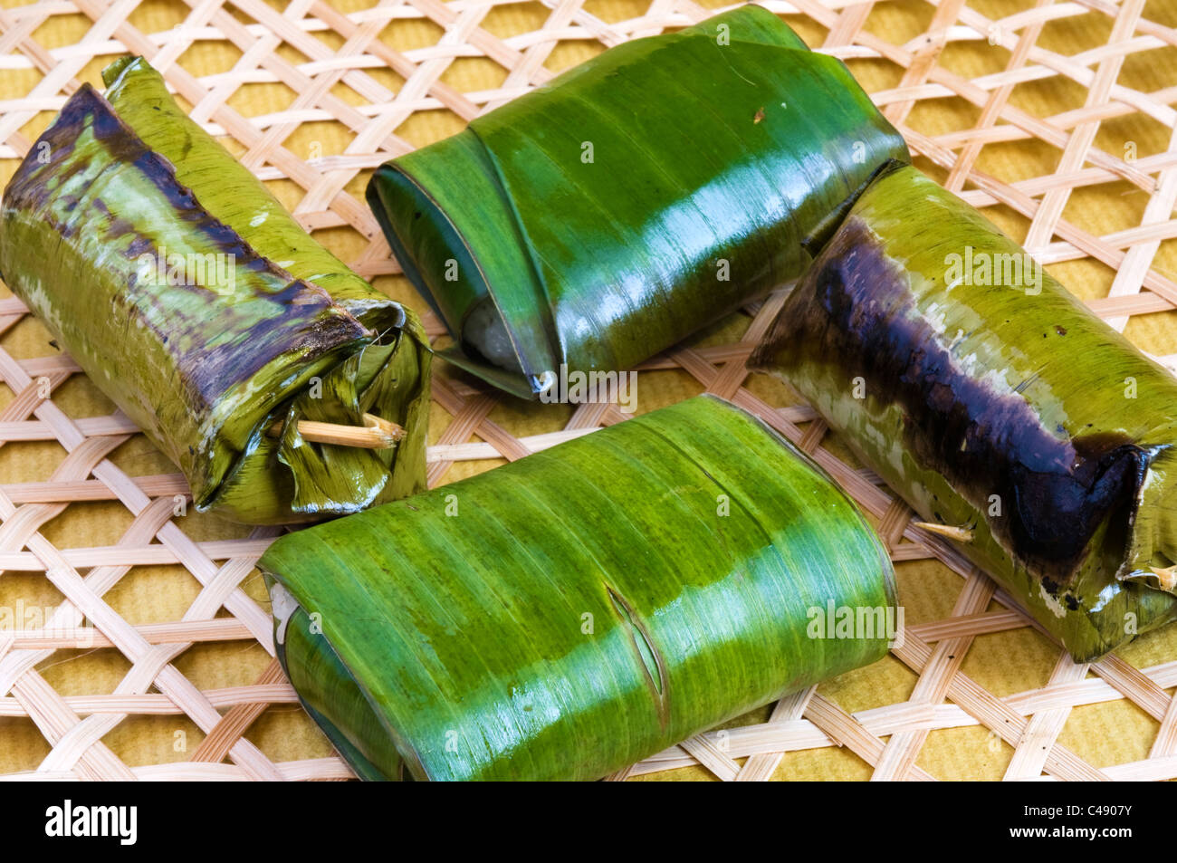 Indonesian leaf-wrapped sticky rice snacks - lempar Stock Photo - Alamy