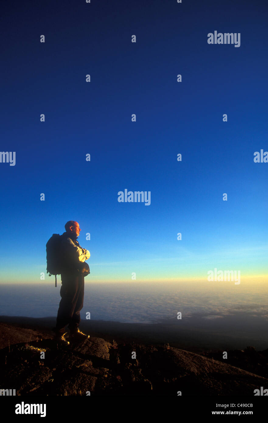 Man stands looks mountains hi-res stock photography and images - Alamy