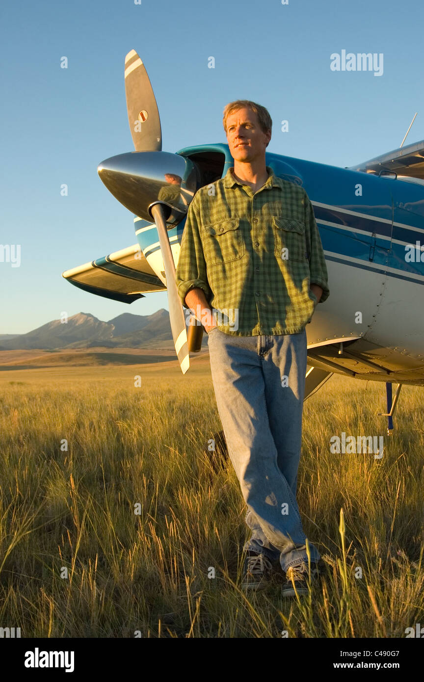 Pilot stands on airplane background hi-res stock photography and images ...