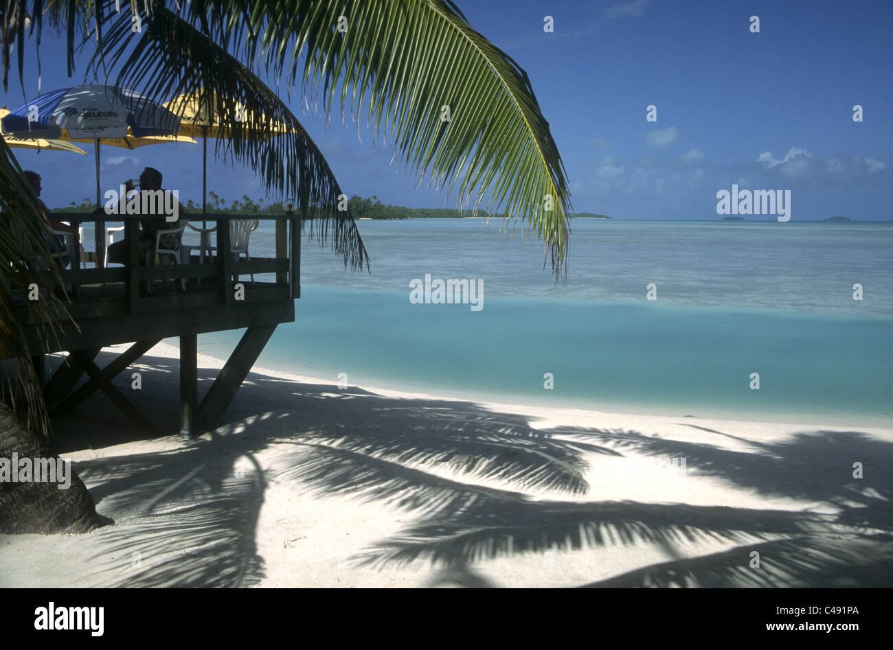 Tourist enjoy a drink in paradise at the beautiful Blue Lagoon beach ...