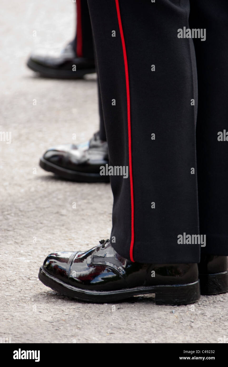 Close-up from the side of the highly polished boots of Scots guardsmen ...