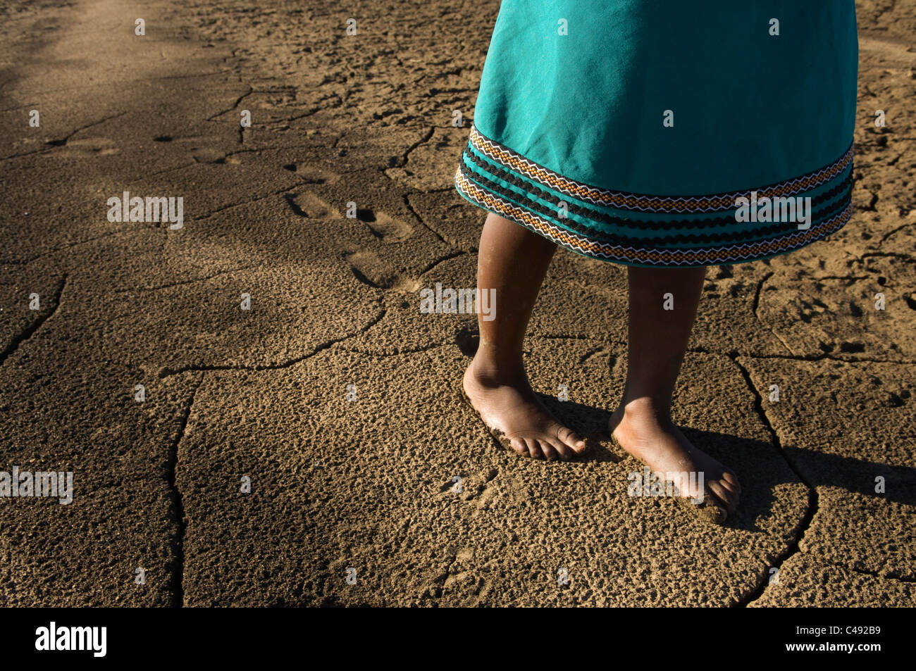 Girl walking barefoot on the lake shore, Spioenkop dam, KwaZulu-Natal ...