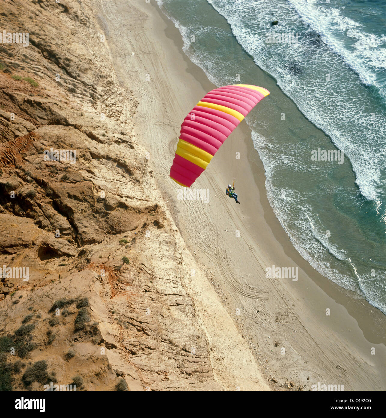 Aerial photograph of free fall parachute flying over the beach of Ga ...