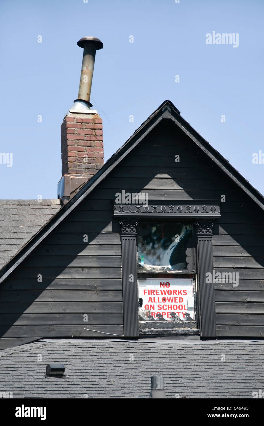 View of upstairs window in second story home with sign posted in window ...