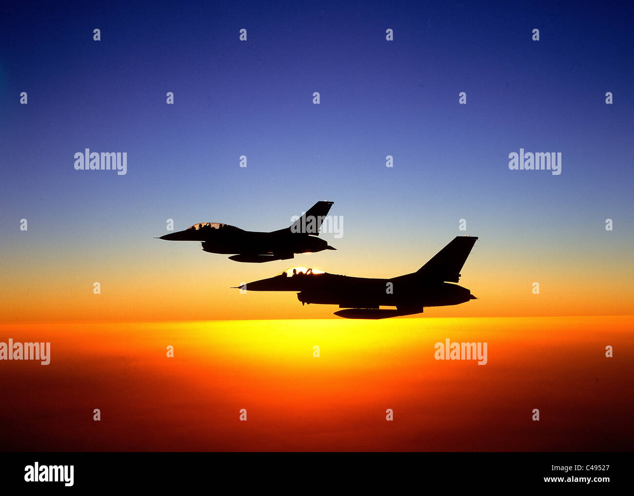 Aerial photograph of two F-16 at sunset Stock Photo - Alamy