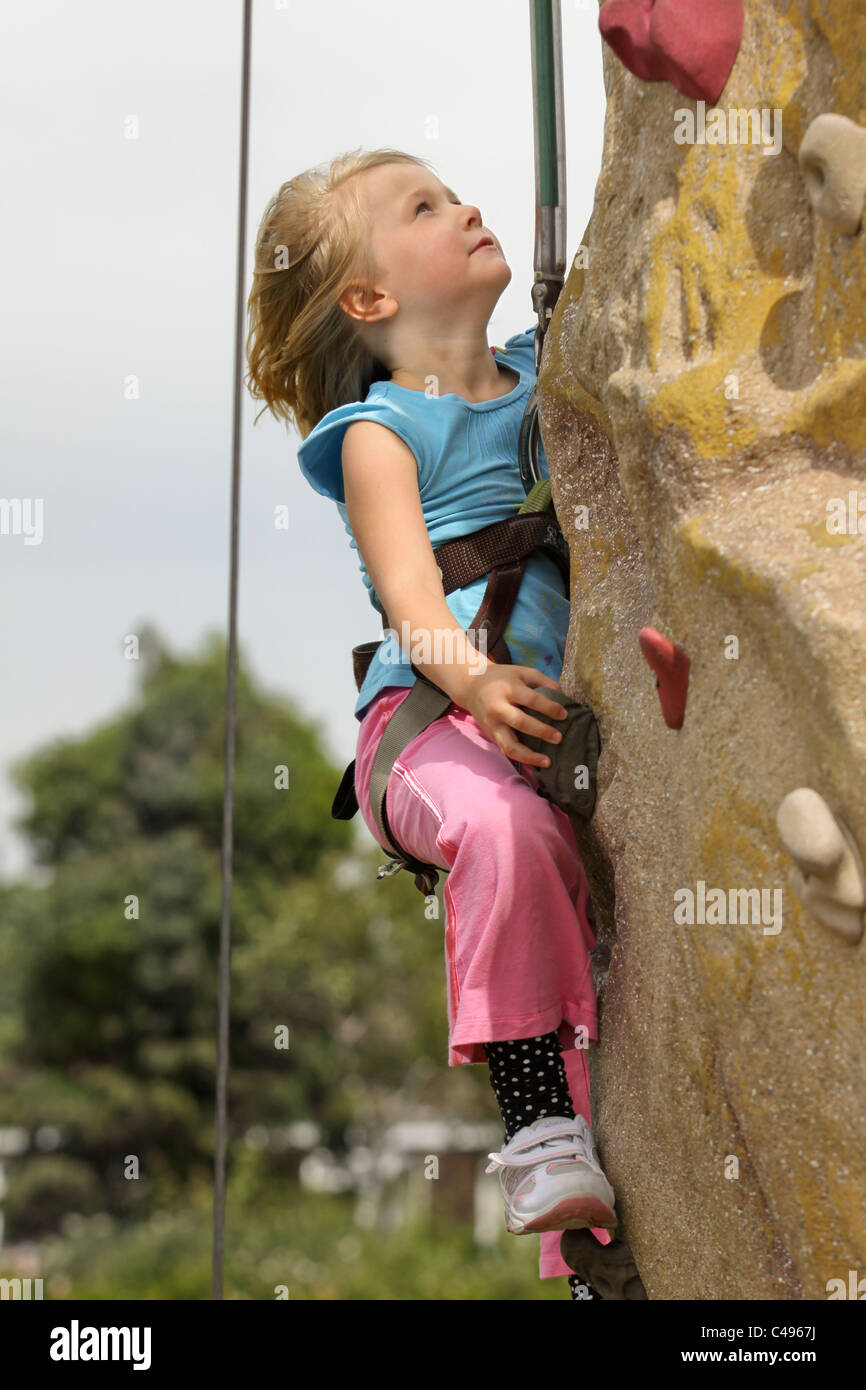 Brave young child on climbing wall Stock Photo - Alamy