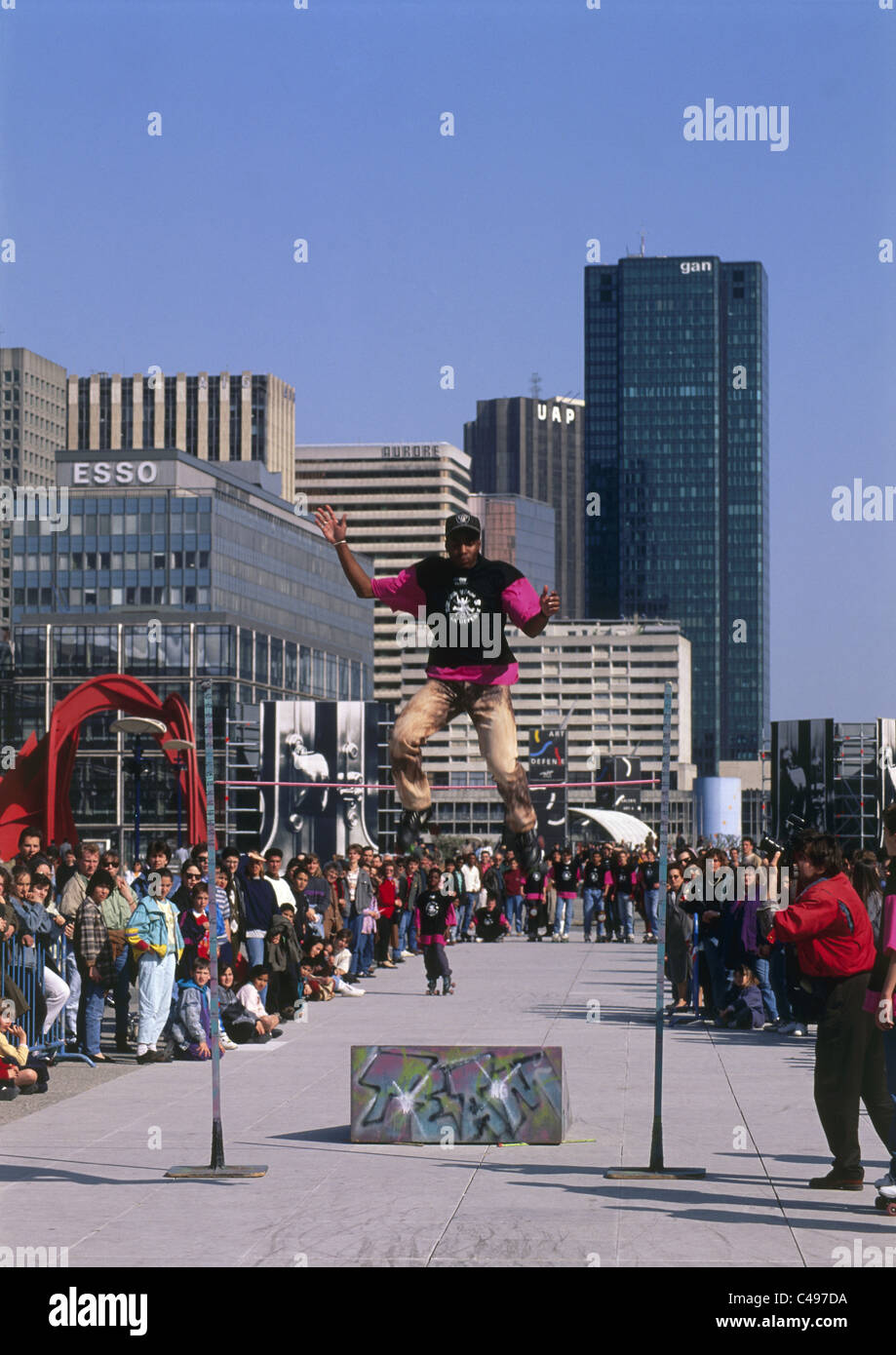 Photograph of a guy making a jump with his rollerblades on a boardwalk ...