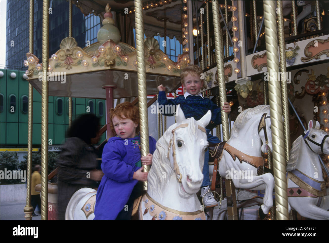 Photograph of children riding wooden horses on a merry-go-round in ...
