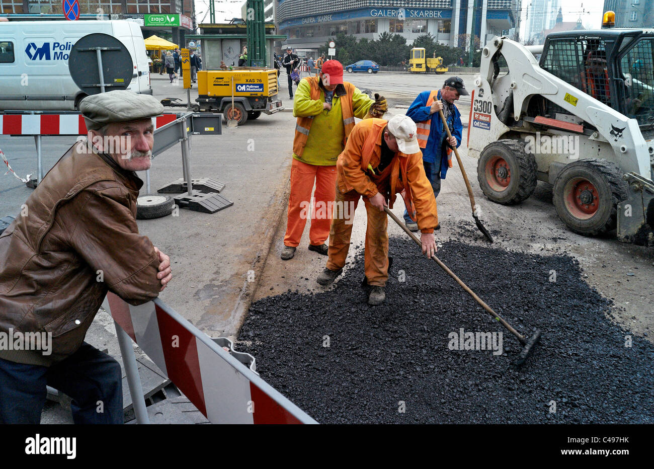 Construction workers repairing a street with asphalt, Katowice, Poland ...
