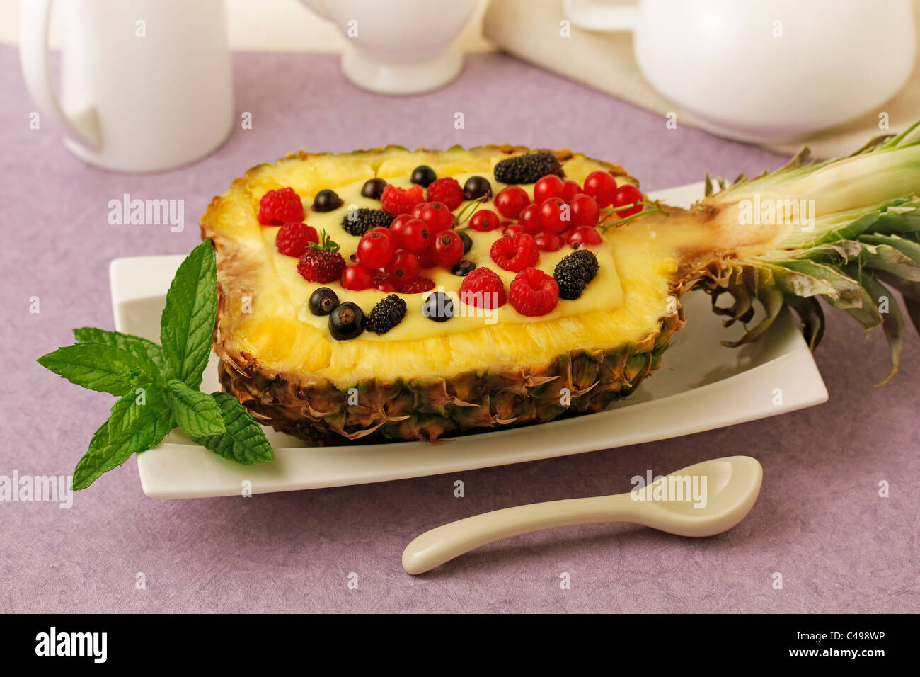 Stuffed pineapple with custard and berries.. Recipe available Stock ...
