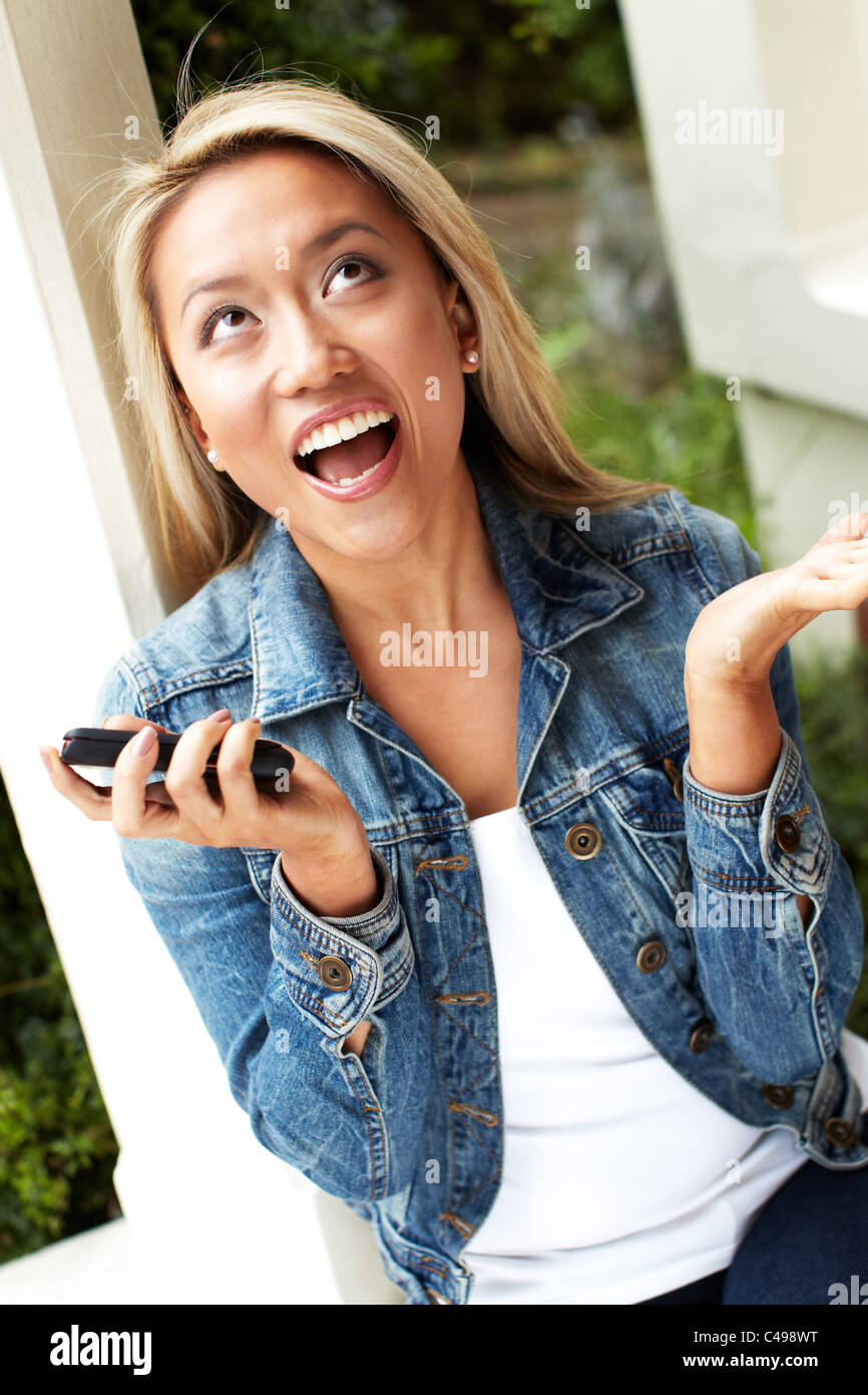 Girl excited receiving message on her phone Stock Photo - Alamy