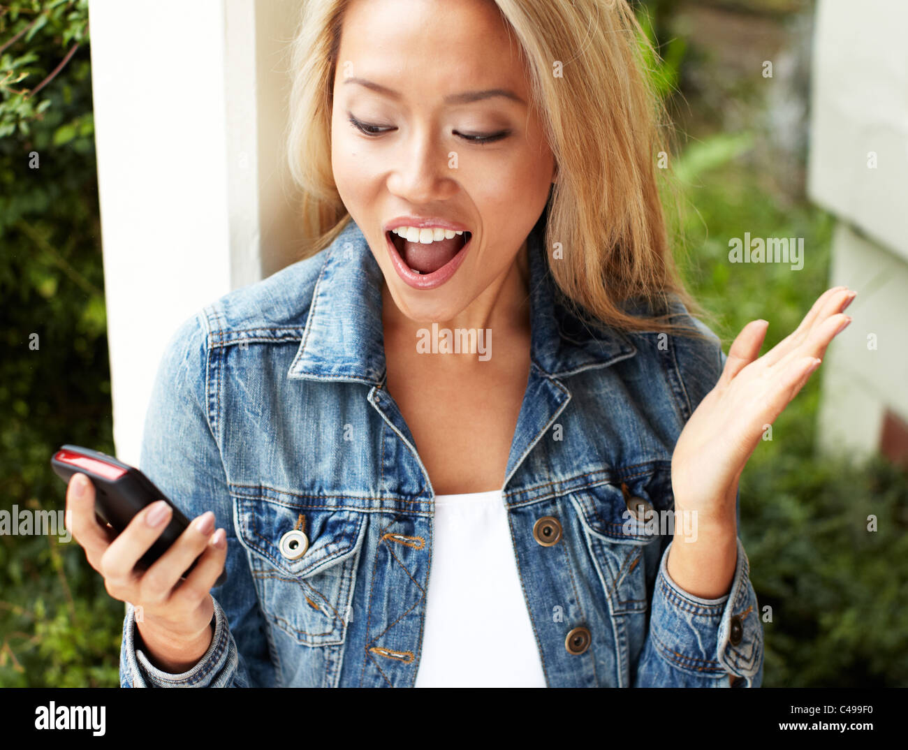 Girl excited receiving message on her phone Stock Photo - Alamy