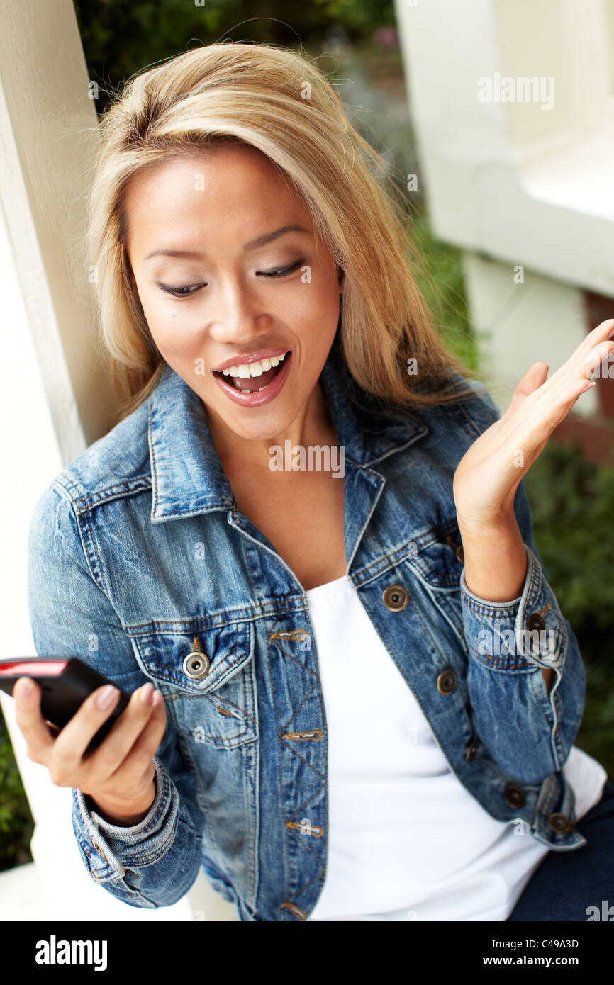 Girl excited receiving message on her phone Stock Photo - Alamy