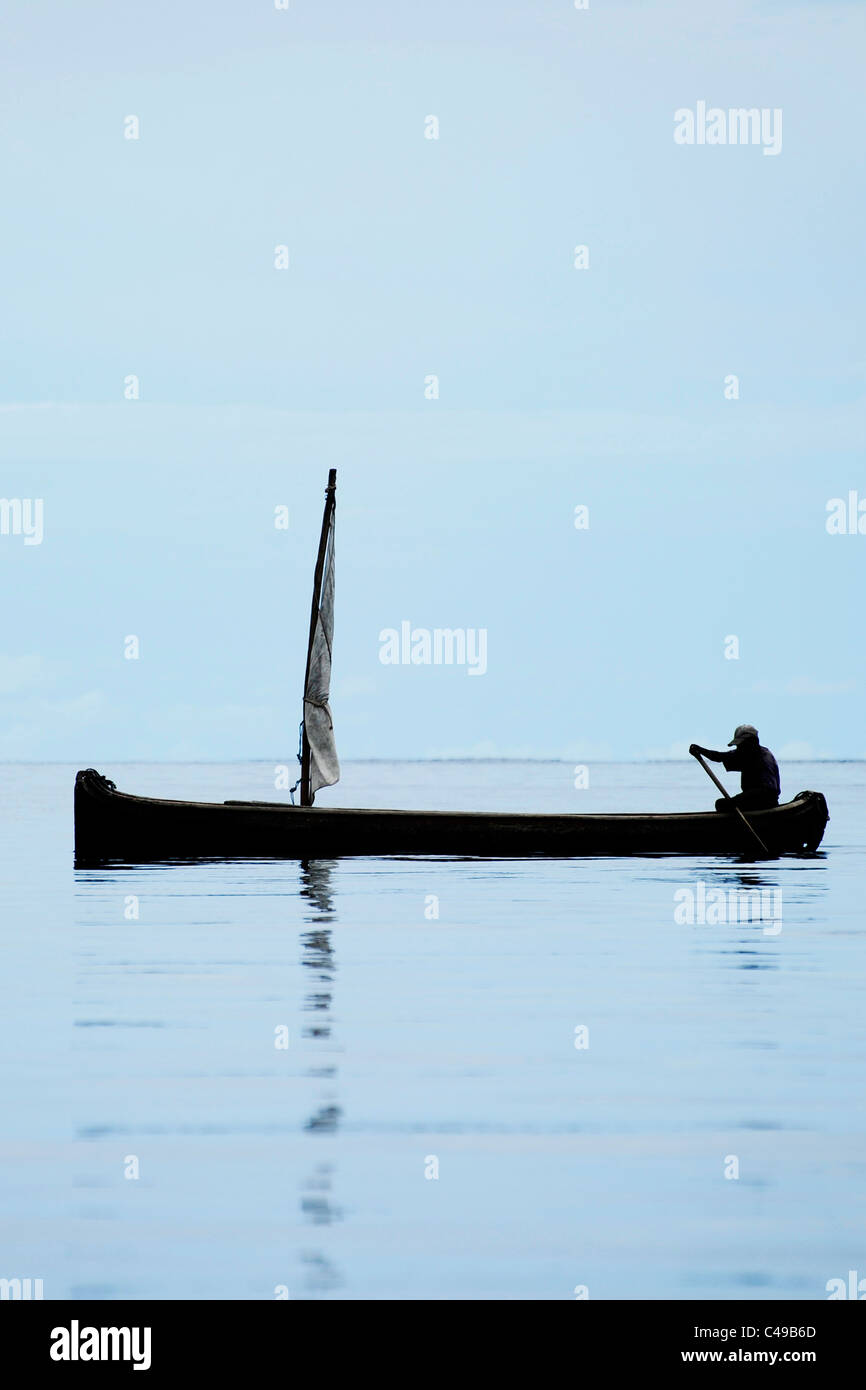 View of an indigenous Kuna man rowing his boat in San Blas archipelago ...
