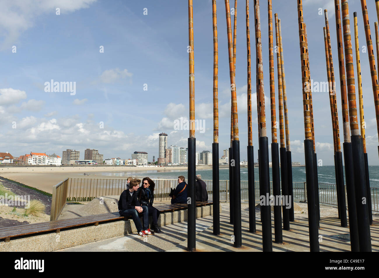 People listening to the sound of the bamboo wind pipes near the beach ...