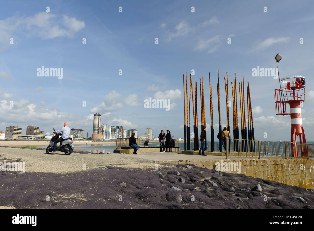 People listening to the sound of the bamboo wind pipes near the beach ...