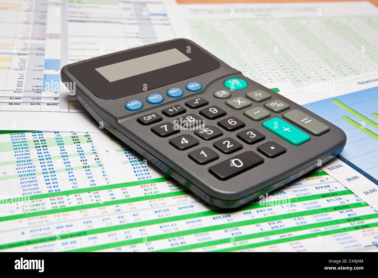 calculator on top of various business documents Stock Photo - Alamy
