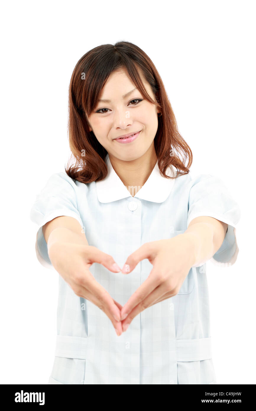 Young asian female nurse shows fingers heart symbol Stock Photo - Alamy