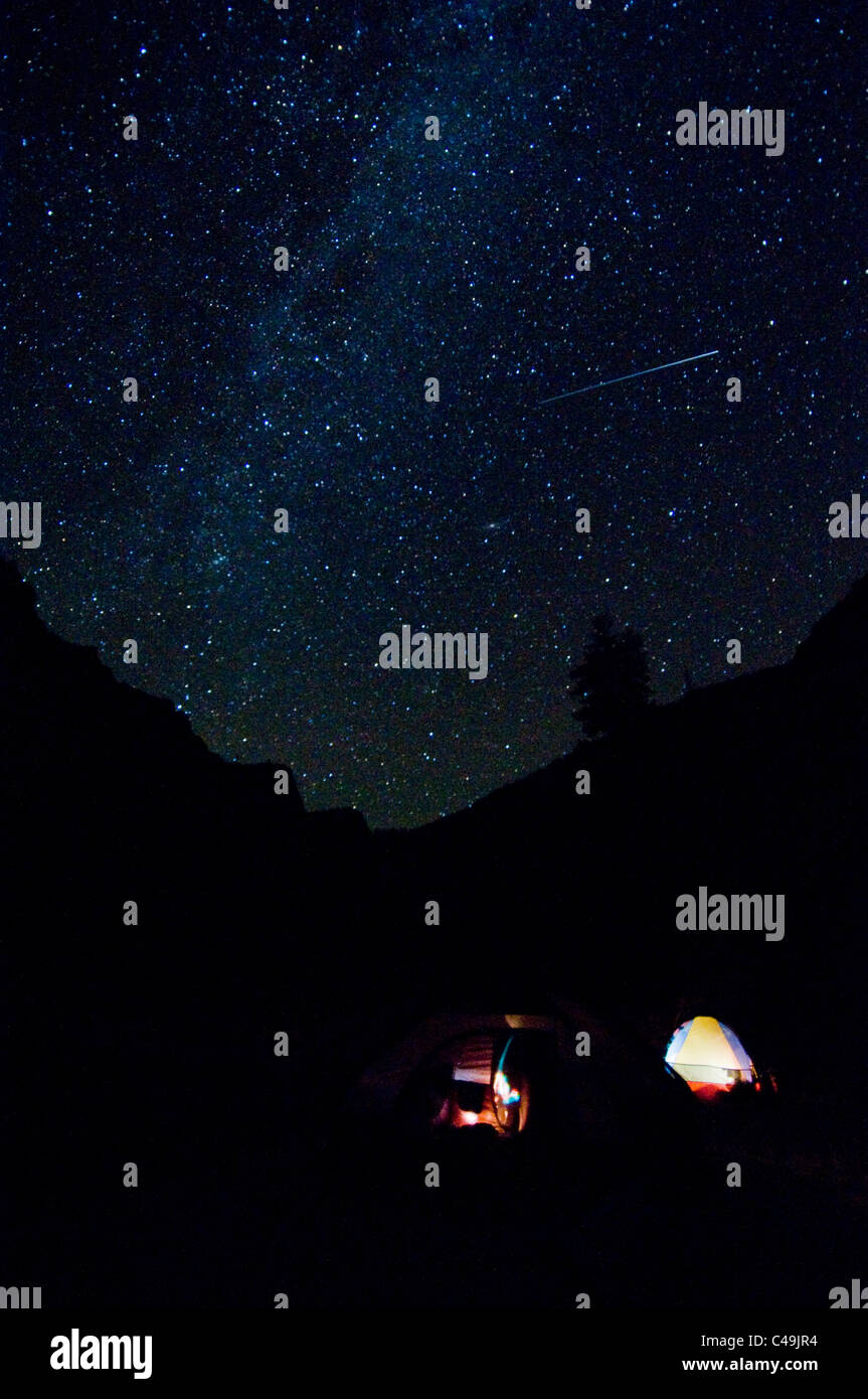 Meteor and Milky Way above two tents at Cliffside Camp on the Middle ...