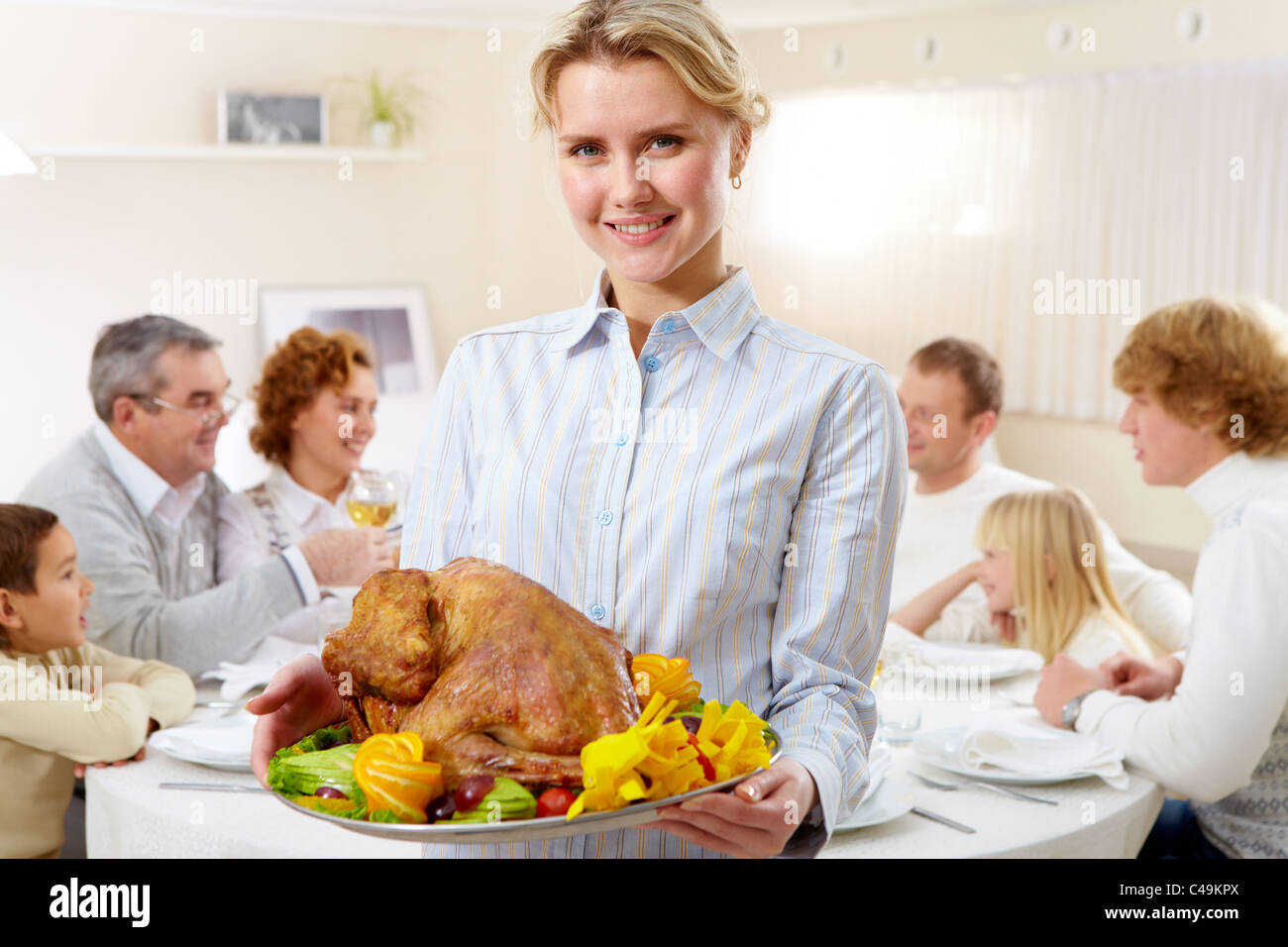 Portrait of pretty woman with roasted turkey on background of happy ...