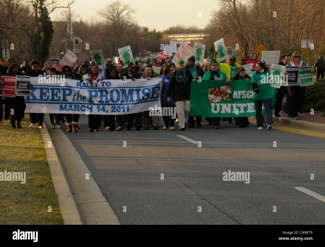 Union protesters march down the street headed for the state house in ...