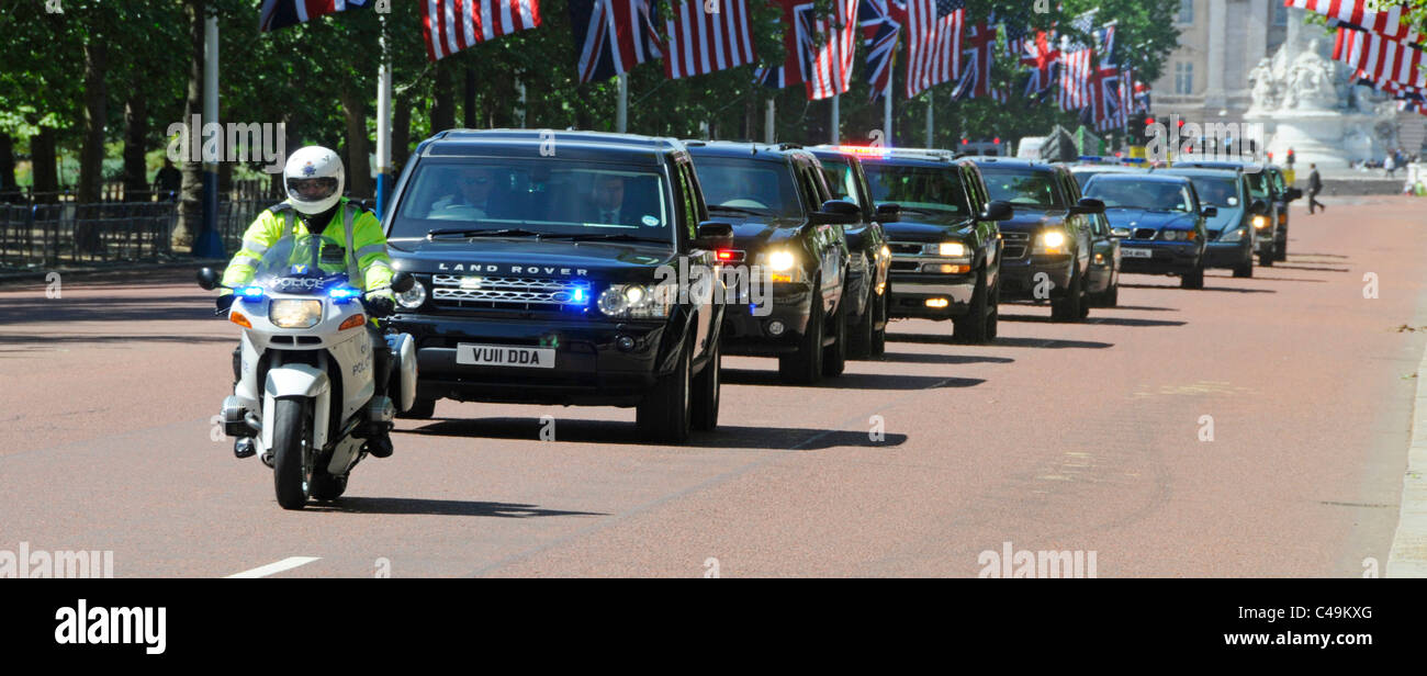 Motorbike Met police & motorcade of UK & USA security guard cars in The ...