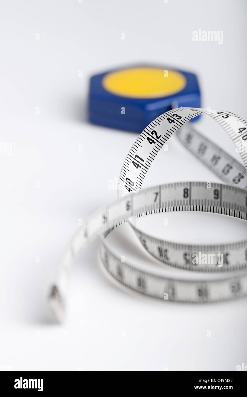 close up of a tape measure rolled on white background Stock Photo - Alamy