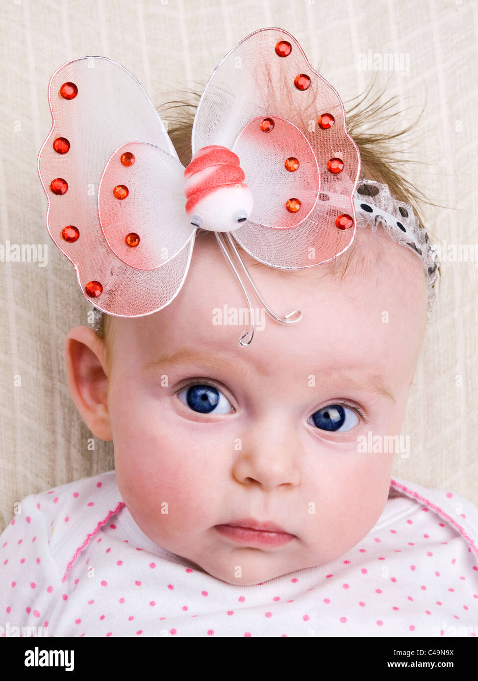 Cute little baby girl with big butterfly on her head Stock Photo - Alamy