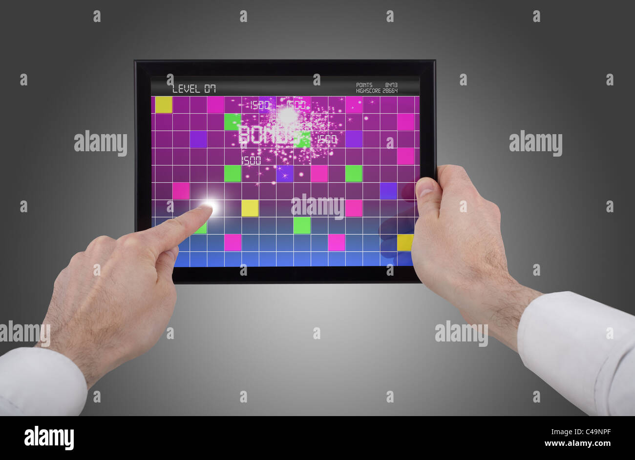 a male hand holding a touchpad pc, one finger touches the screen ...