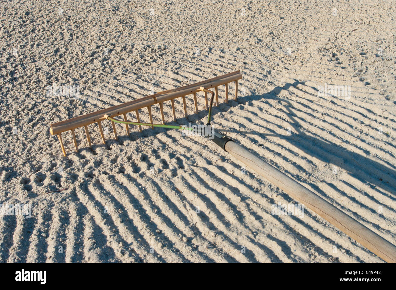 Rake in golf course sand hi-res stock photography and images - Alamy