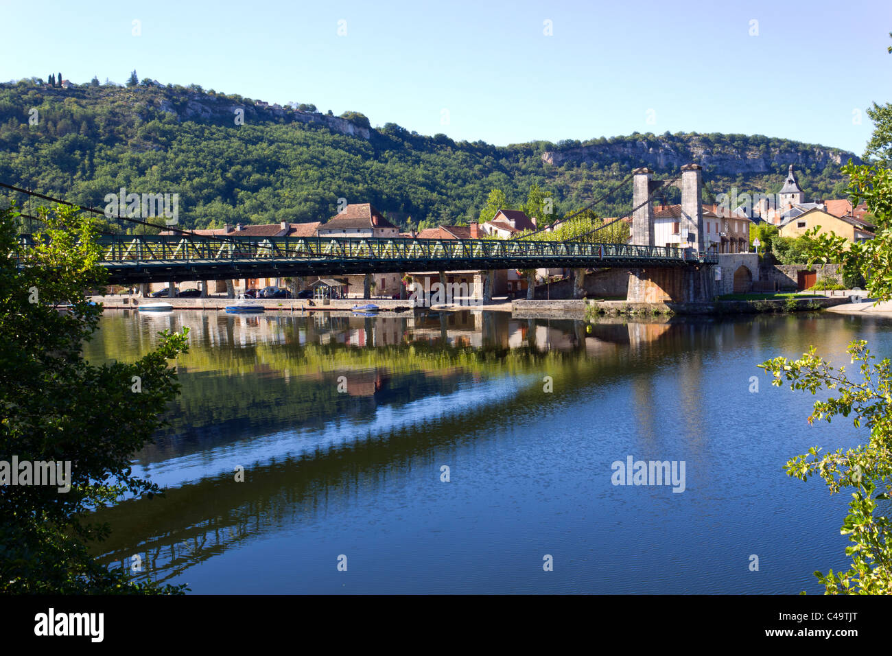 The River Lot and suspension bridge at picturesque Cajarc in the Lot ...