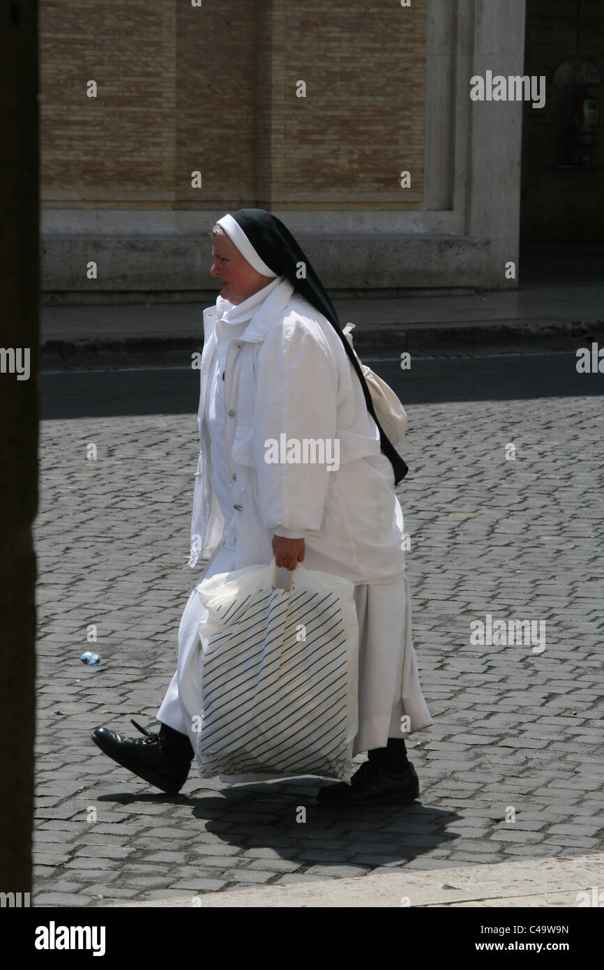 nun walking in street in rome Stock Photo - Alamy