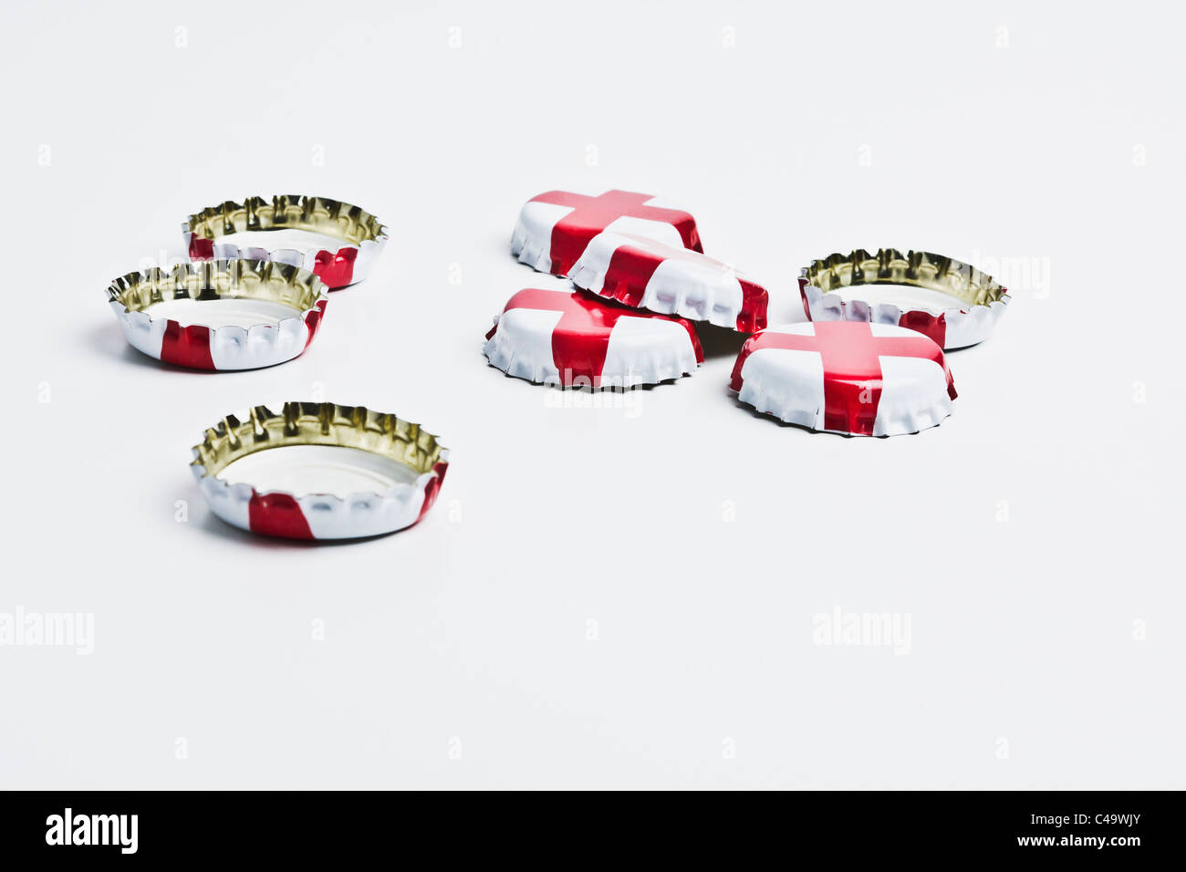 Eight beer bottle caps with the St Georges Cross emblem on white ...