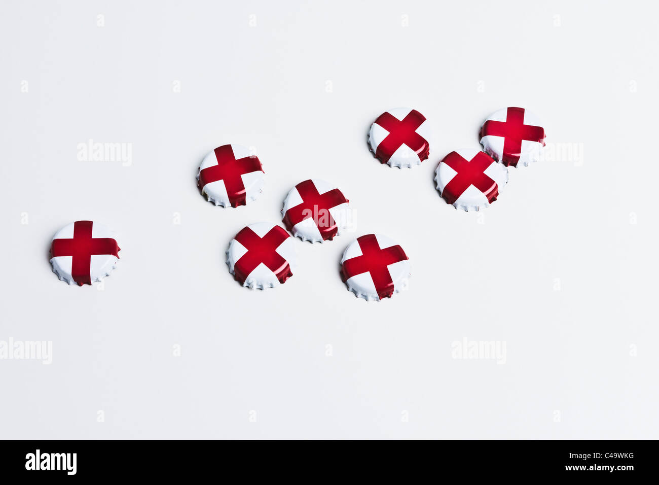 Eight beer bottle caps with the St Georges Cross emblem on white ...