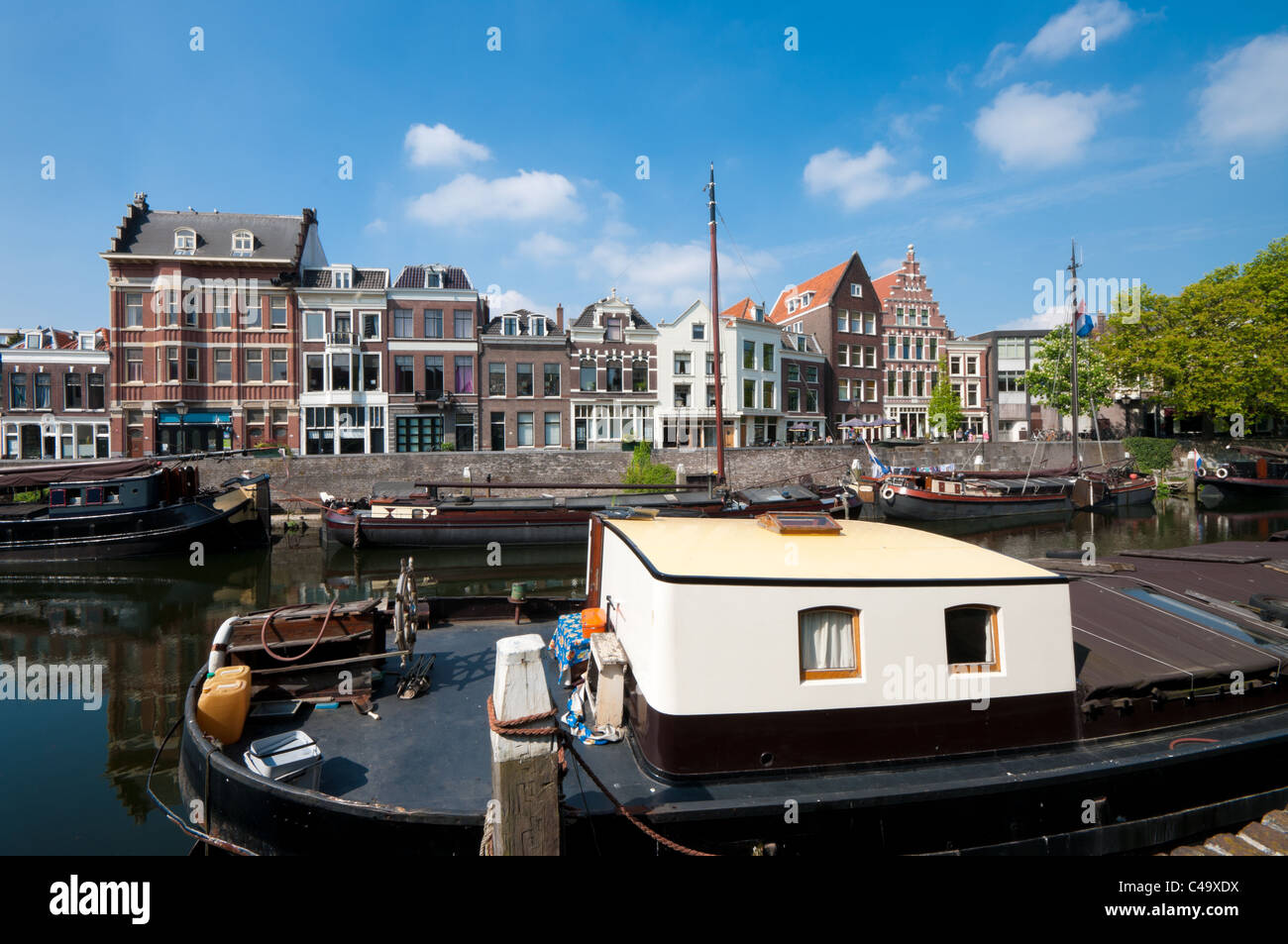 houseboats and barges in canal in delfshaven, netherlands Stock Photo ...